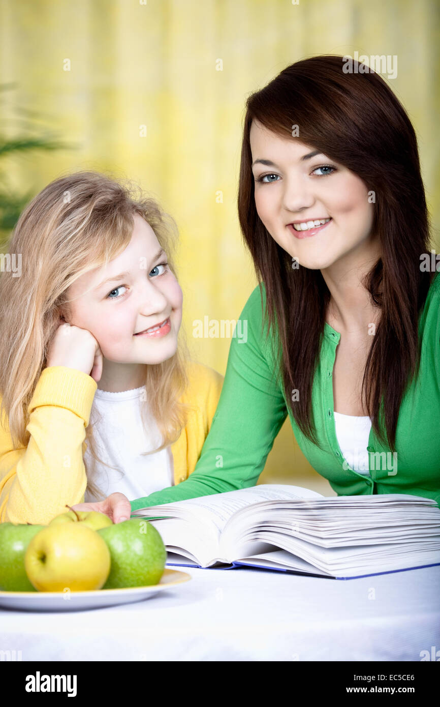 girls reading a book at home Stock Photo - Alamy