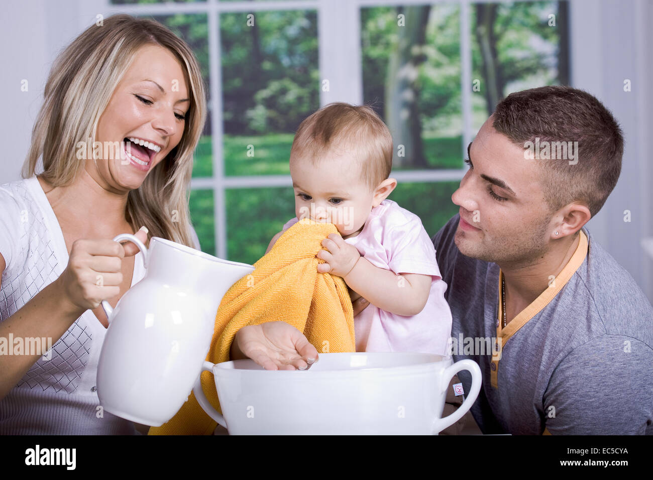 parents washing the small baby in the bathtub Stock Photo - Alamy