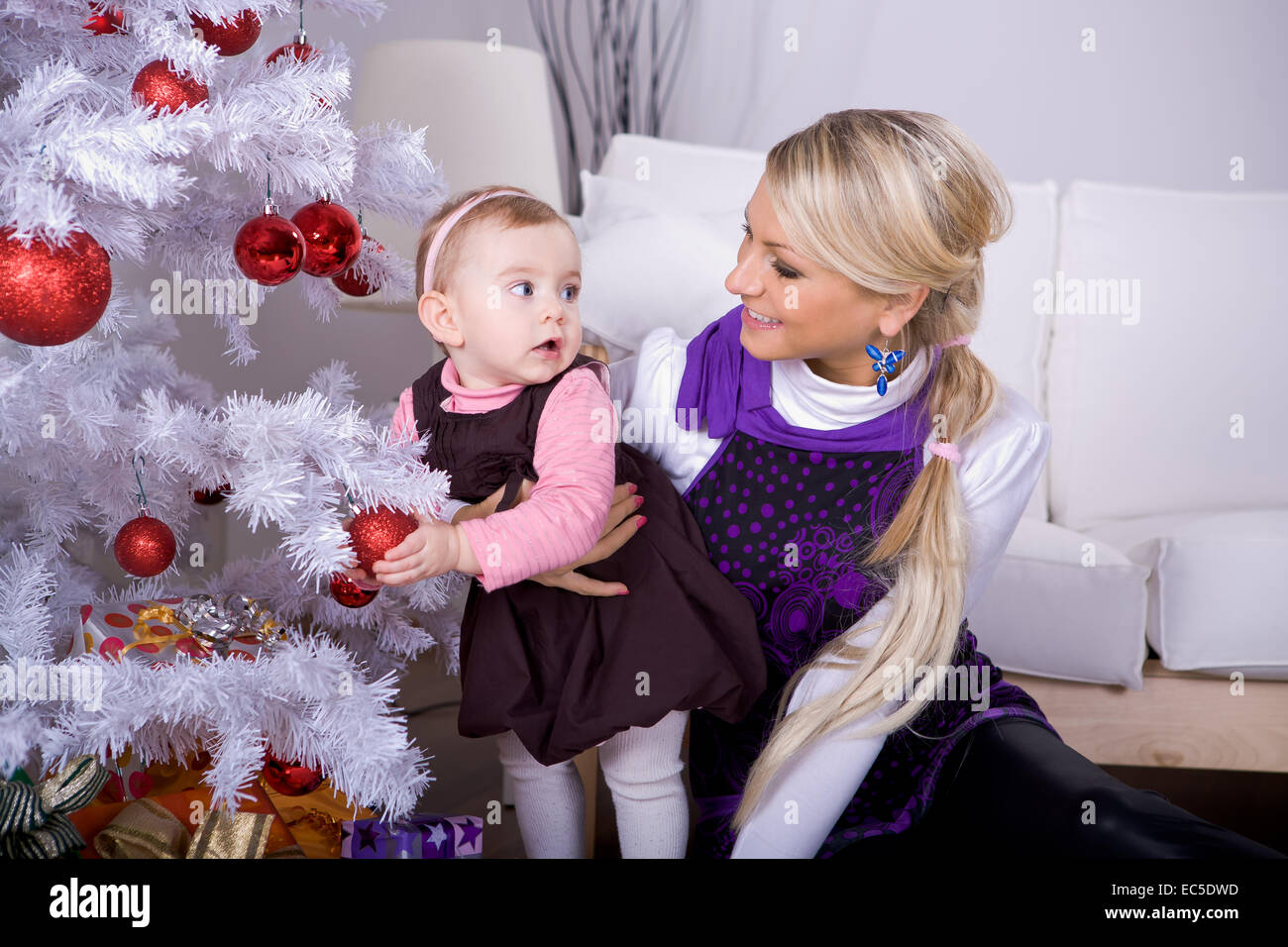 a young family getting the Christmas gift Stock Photo - Alamy