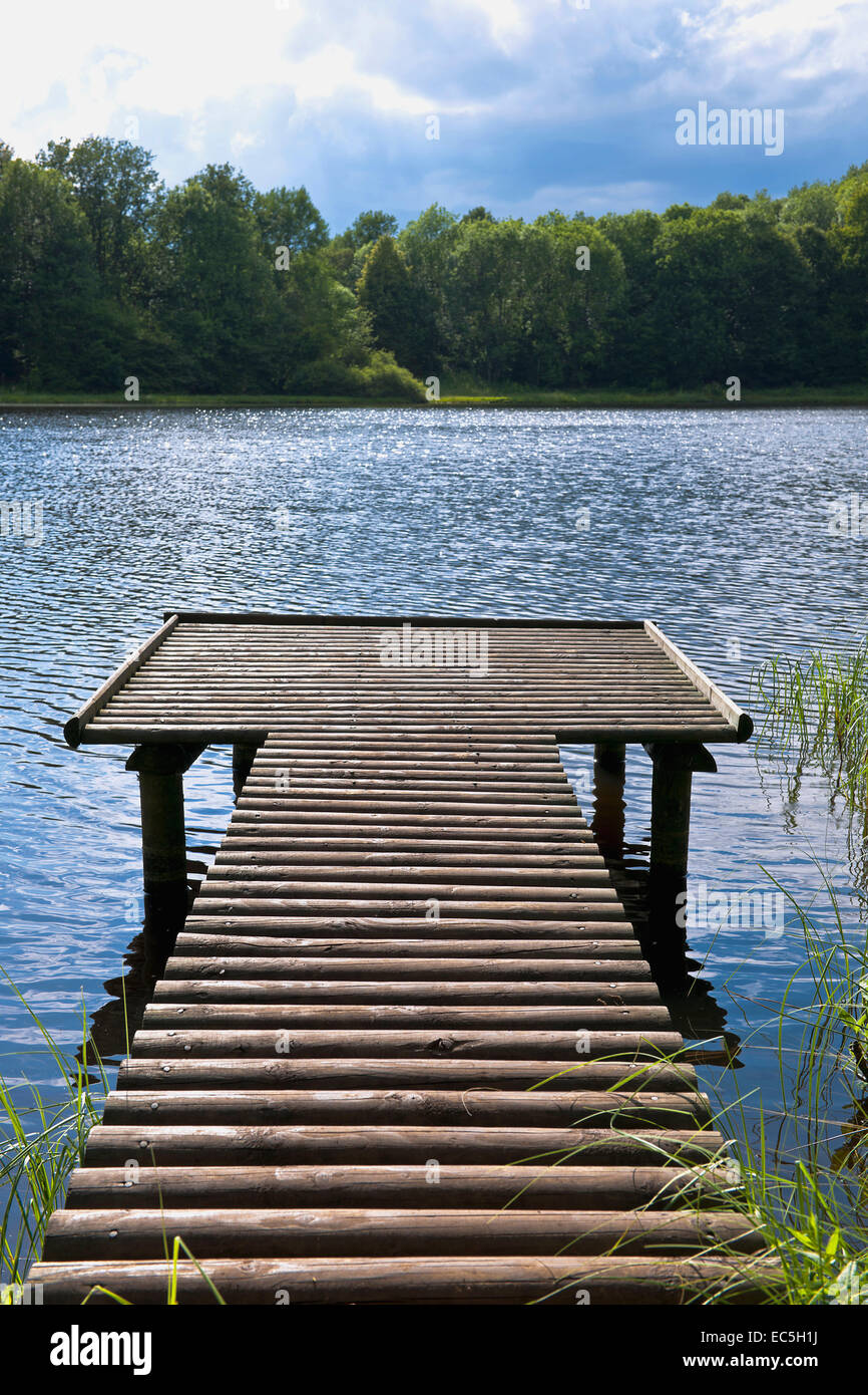 wooden landing stage and an idyllic lake Stock Photo - Alamy