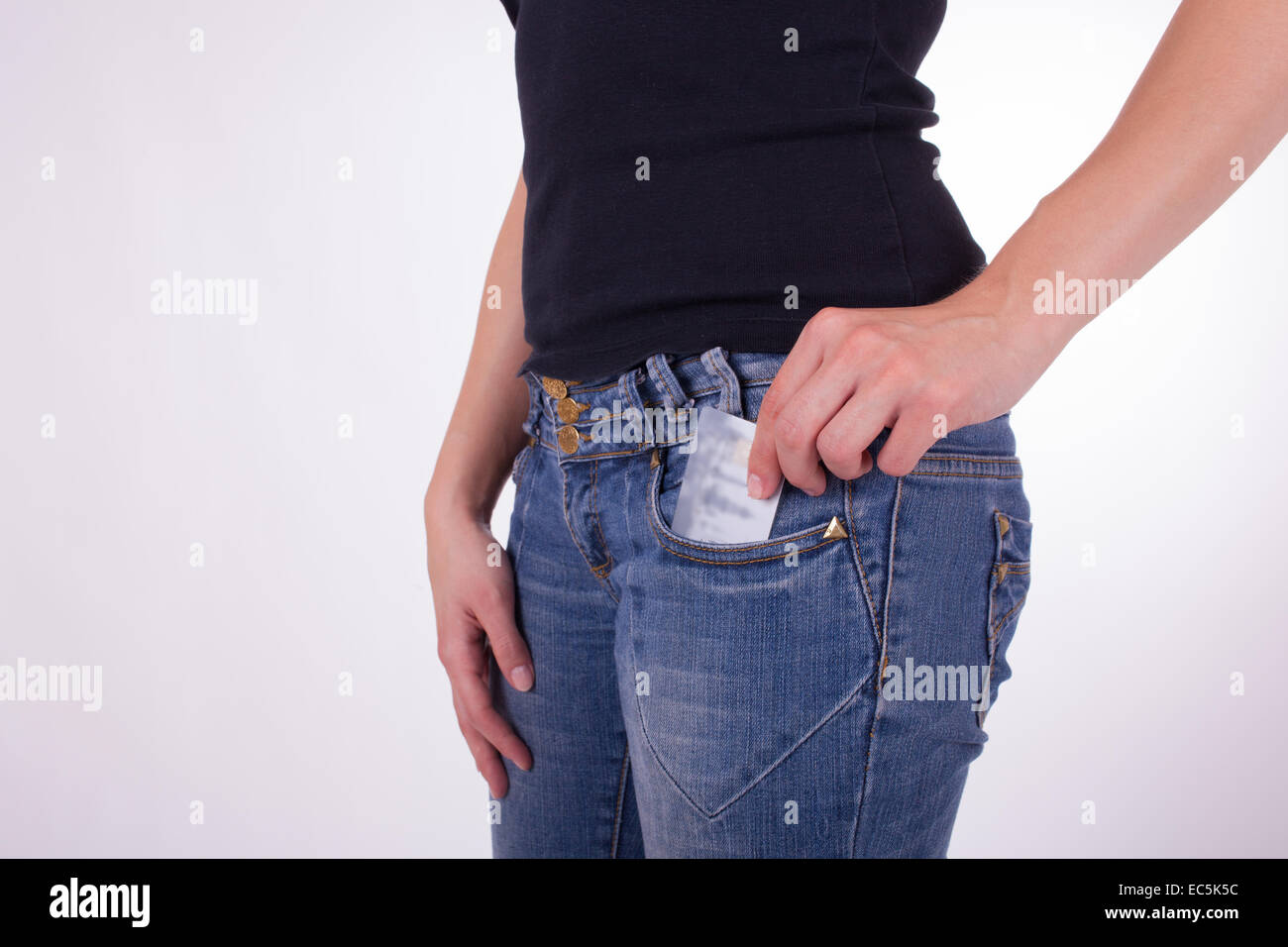 A Young woman is pulling a credit card out of her pocket Stock Photo ...