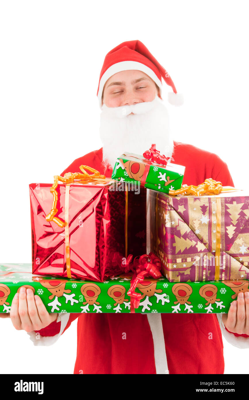 Santa Claus loaded with Christmas gifts Stock Photo - Alamy
