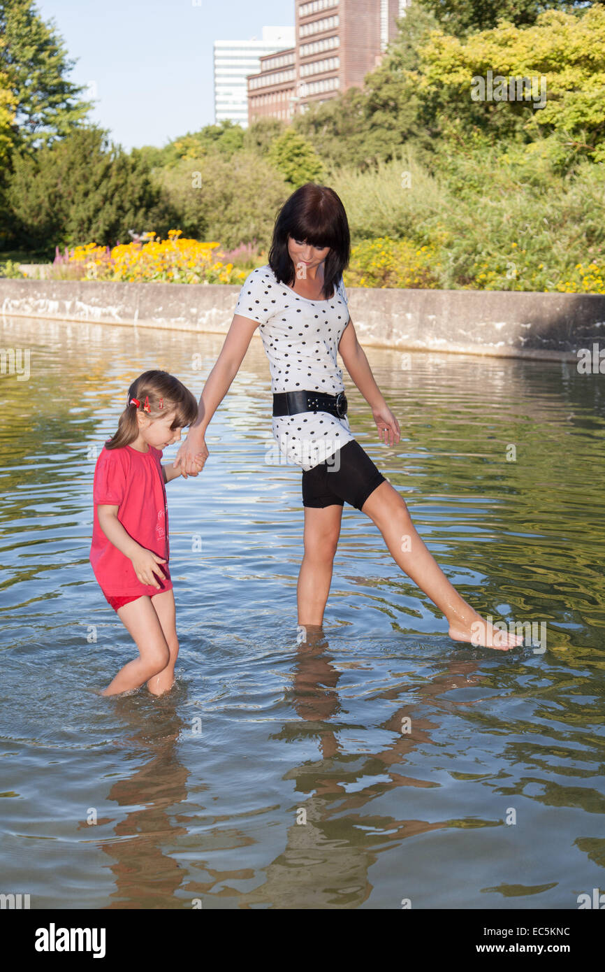 Mother and daughter playing in the water Stock Photo - Alamy