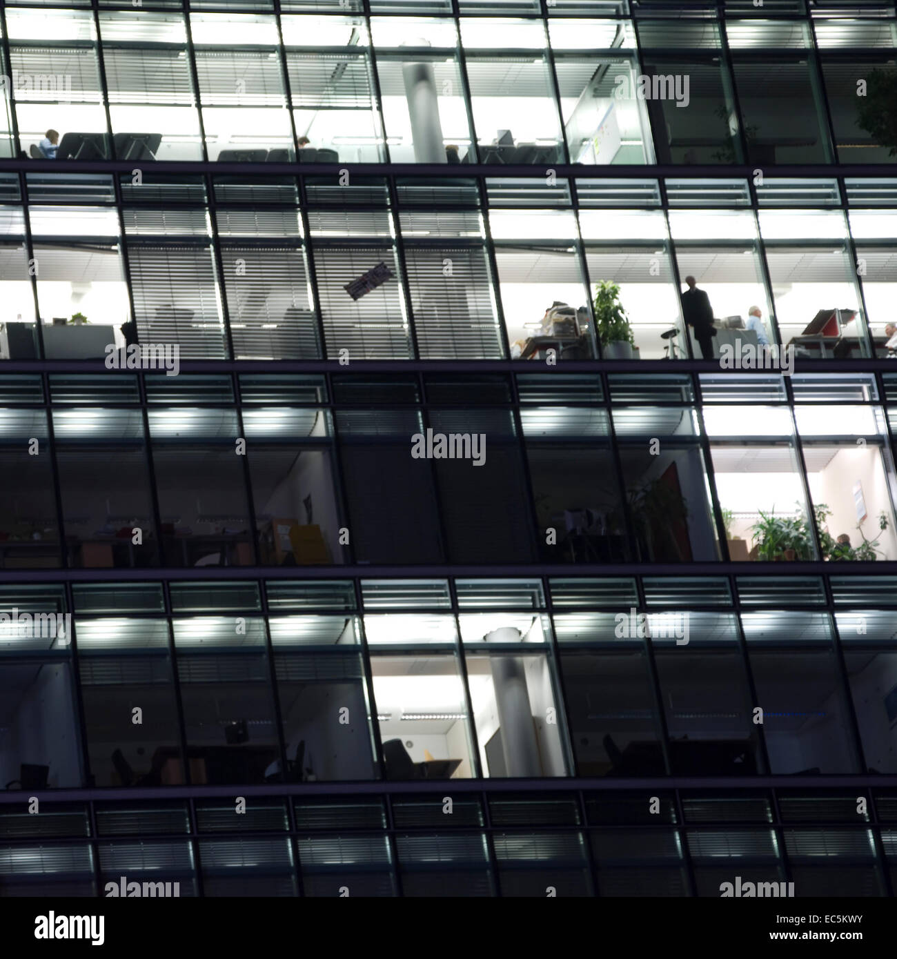 facade of a modern office building with the shadow of a business man ...