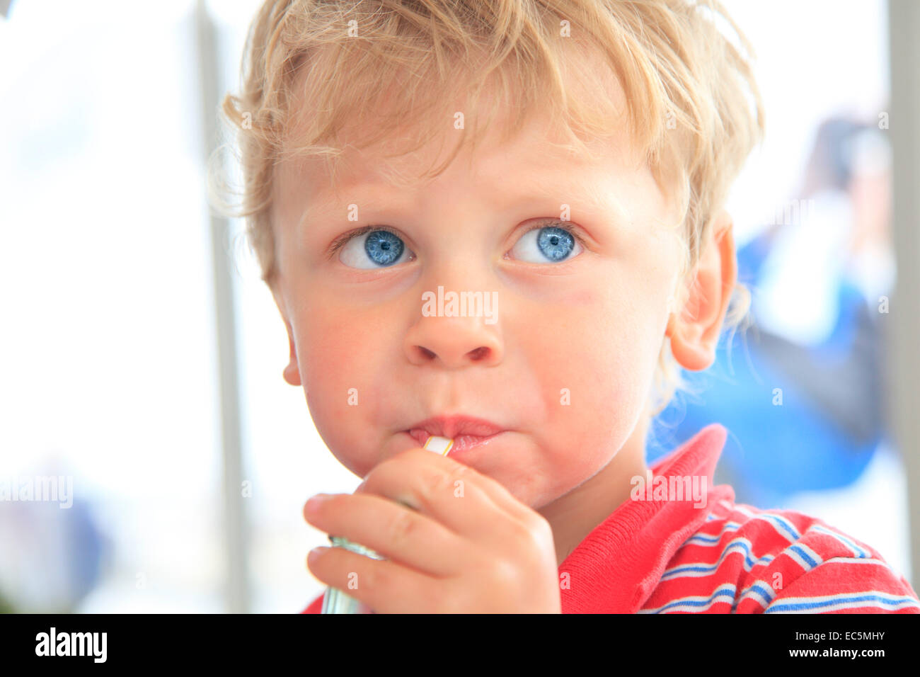 Boy with drinking straw Stock Photo - Alamy