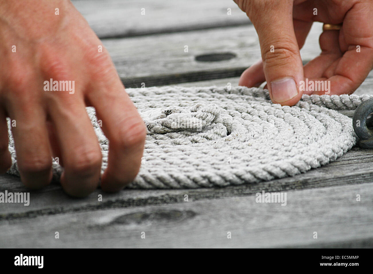 male hands organizing a hawser Stock Photo - Alamy
