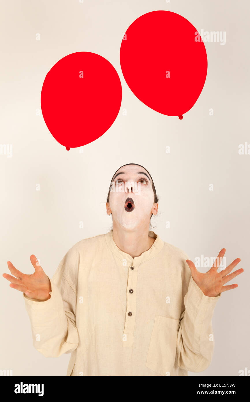 The clown is playing with red balloons Stock Photo - Alamy
