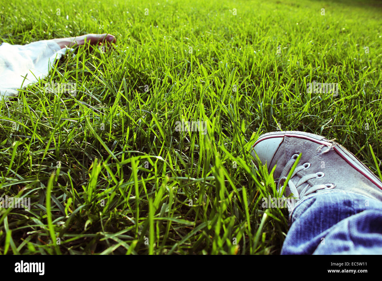 Feet in the grass Stock Photo - Alamy