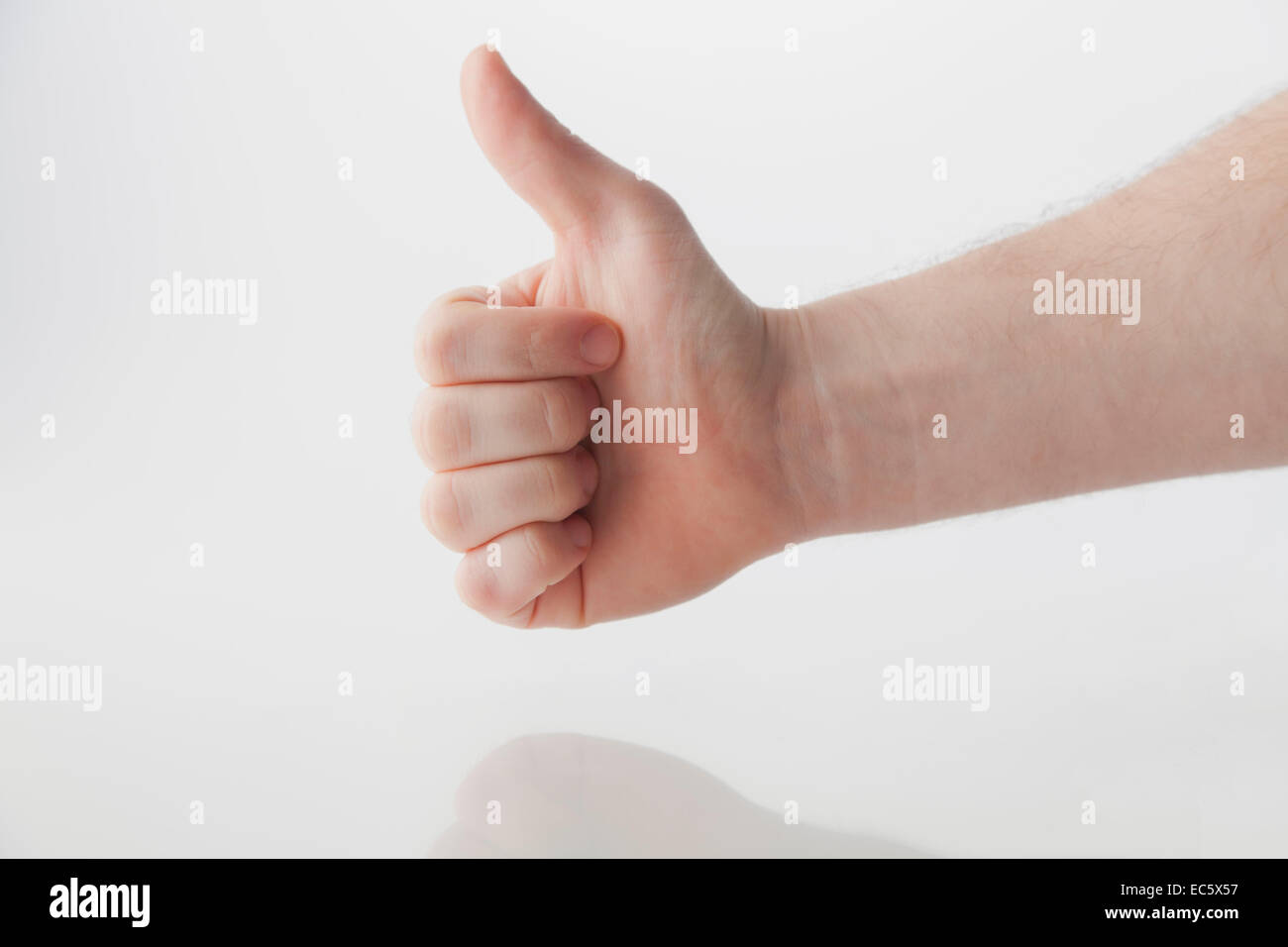 male stretched thumb against white with reflection Stock Photo - Alamy