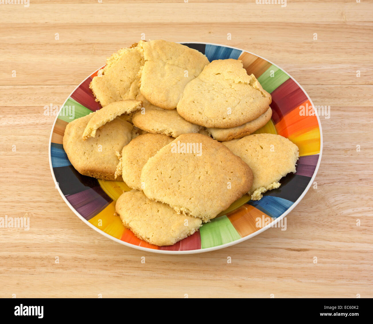 A colorful plate of homemade sugar cookies on a wood table top Stock ...