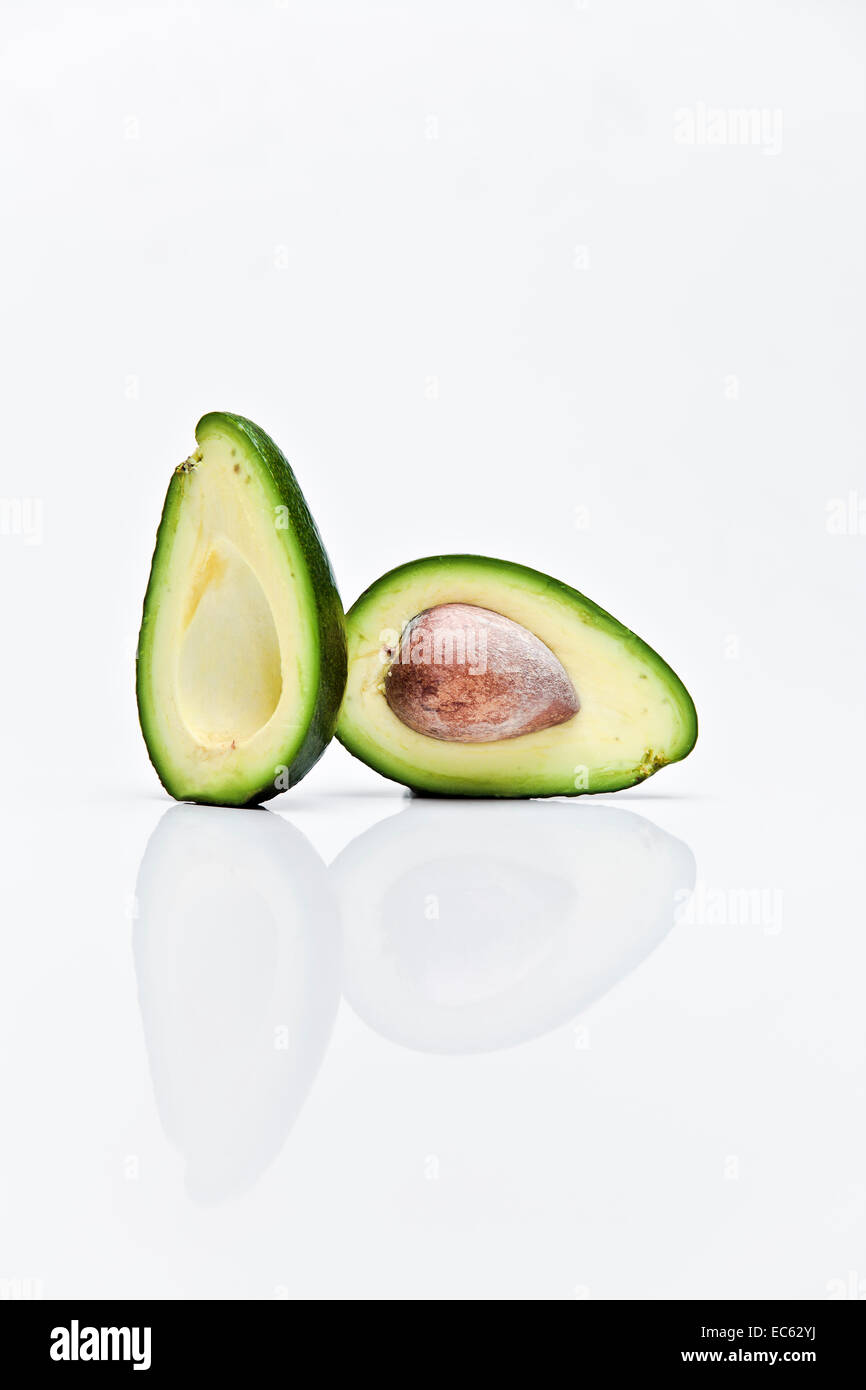 Avocado cut in front of white Stock Photo - Alamy