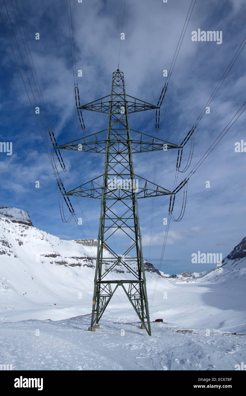 Close up on an electric pylon in the mountain by beautiful winter day ...