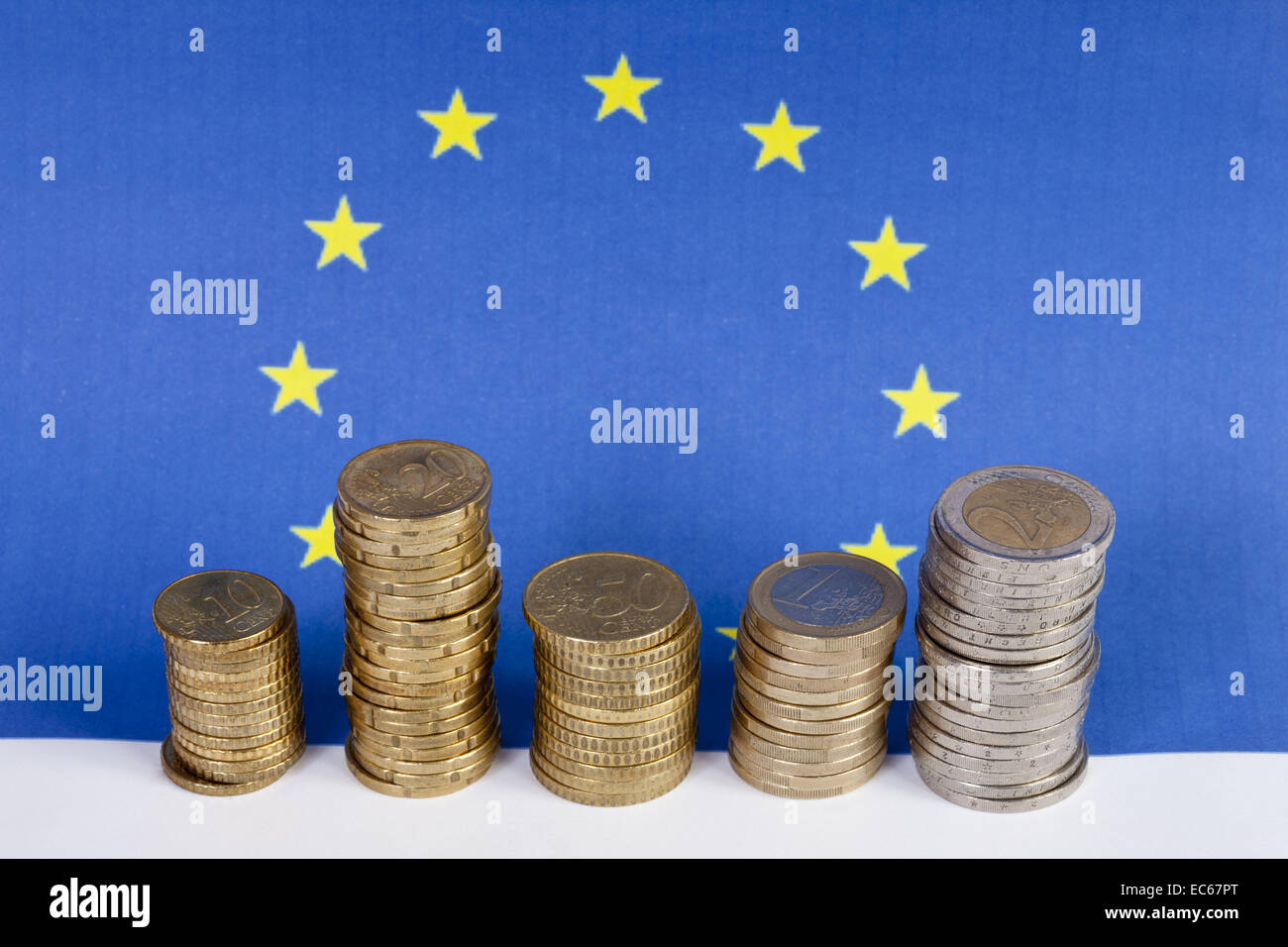 Euro coins in front of the European flag Stock Photo - Alamy