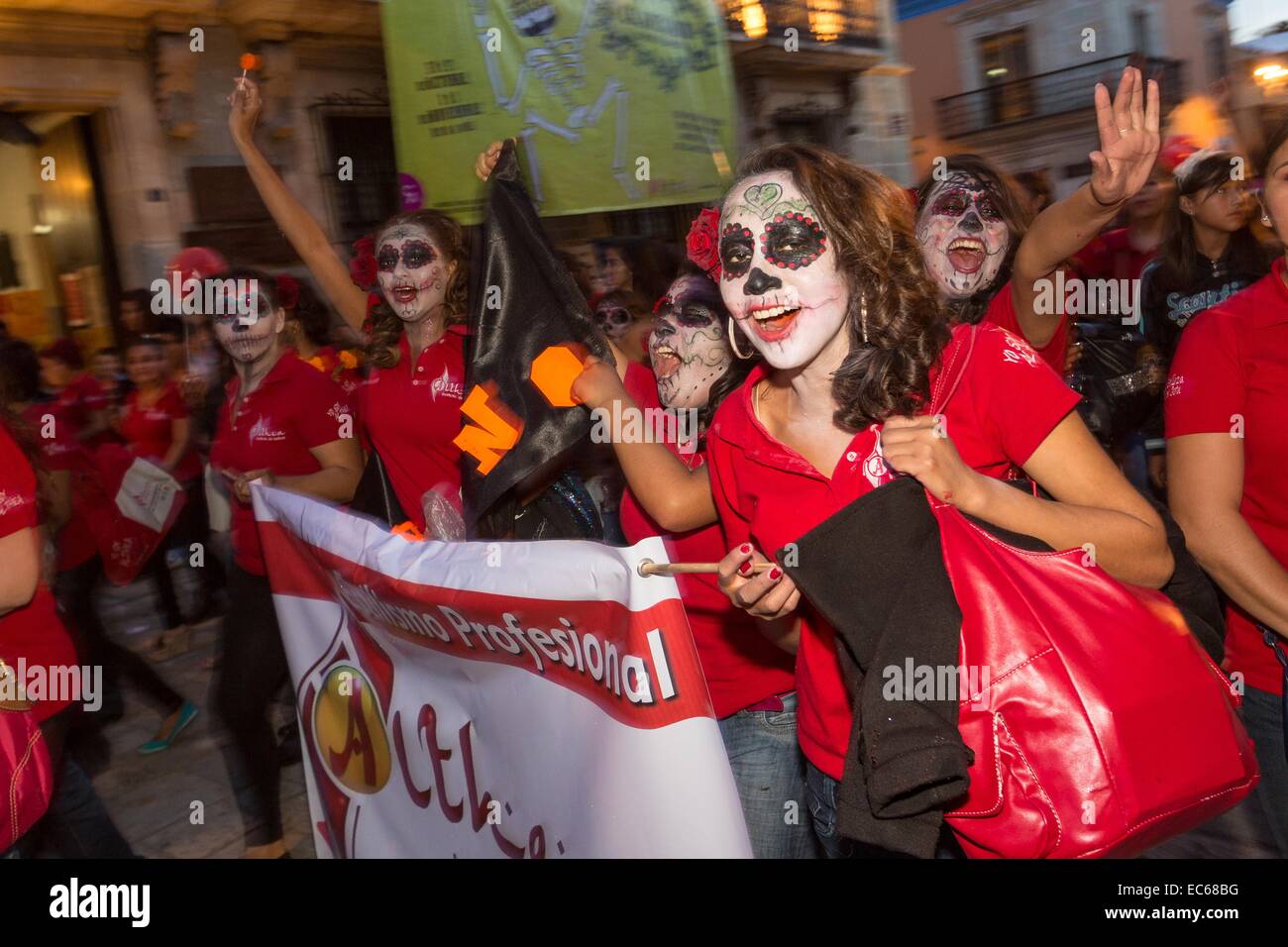 A group of women wearing skeleton face paint parade during the Day of ...