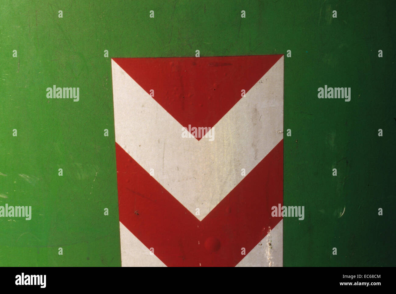 red white sign in front of a green wall Stock Photo - Alamy