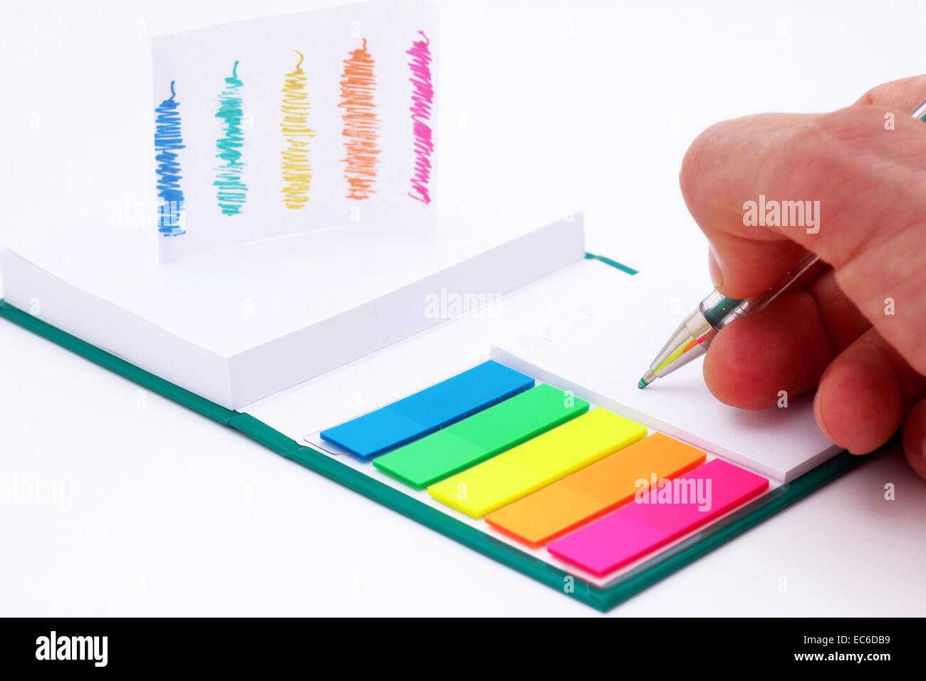 Hand is writing into open note Stock Photo - Alamy