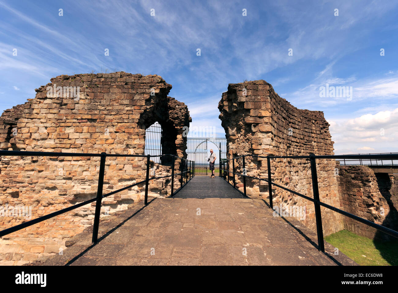Man standing on a bridge, 13th century castle ruins, Flint Castle ...