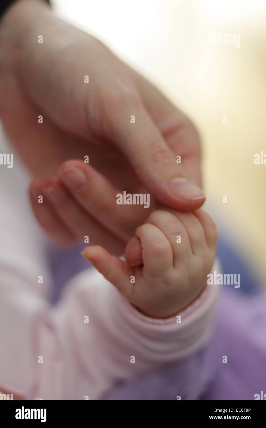 Baby parents hand Stock Photo - Alamy