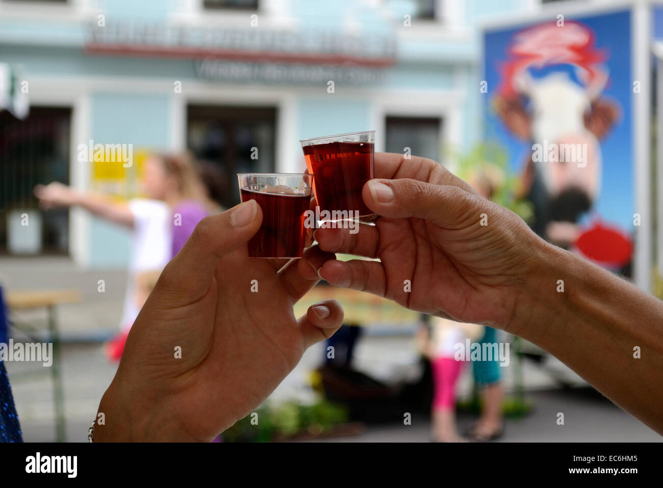 Two people toasting with shot glasses of brandy Stock Photo - Alamy