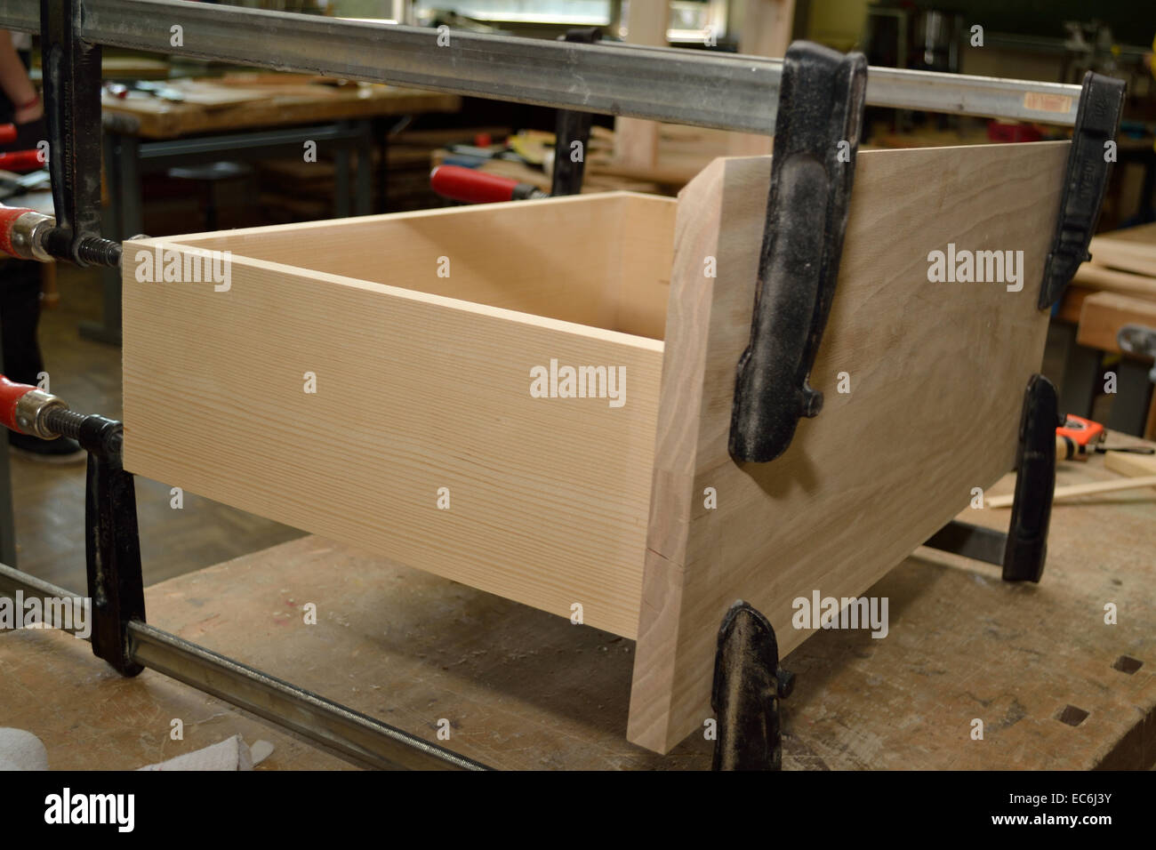 Wooden box with clamps in woodworking shop Stock Photo - Alamy