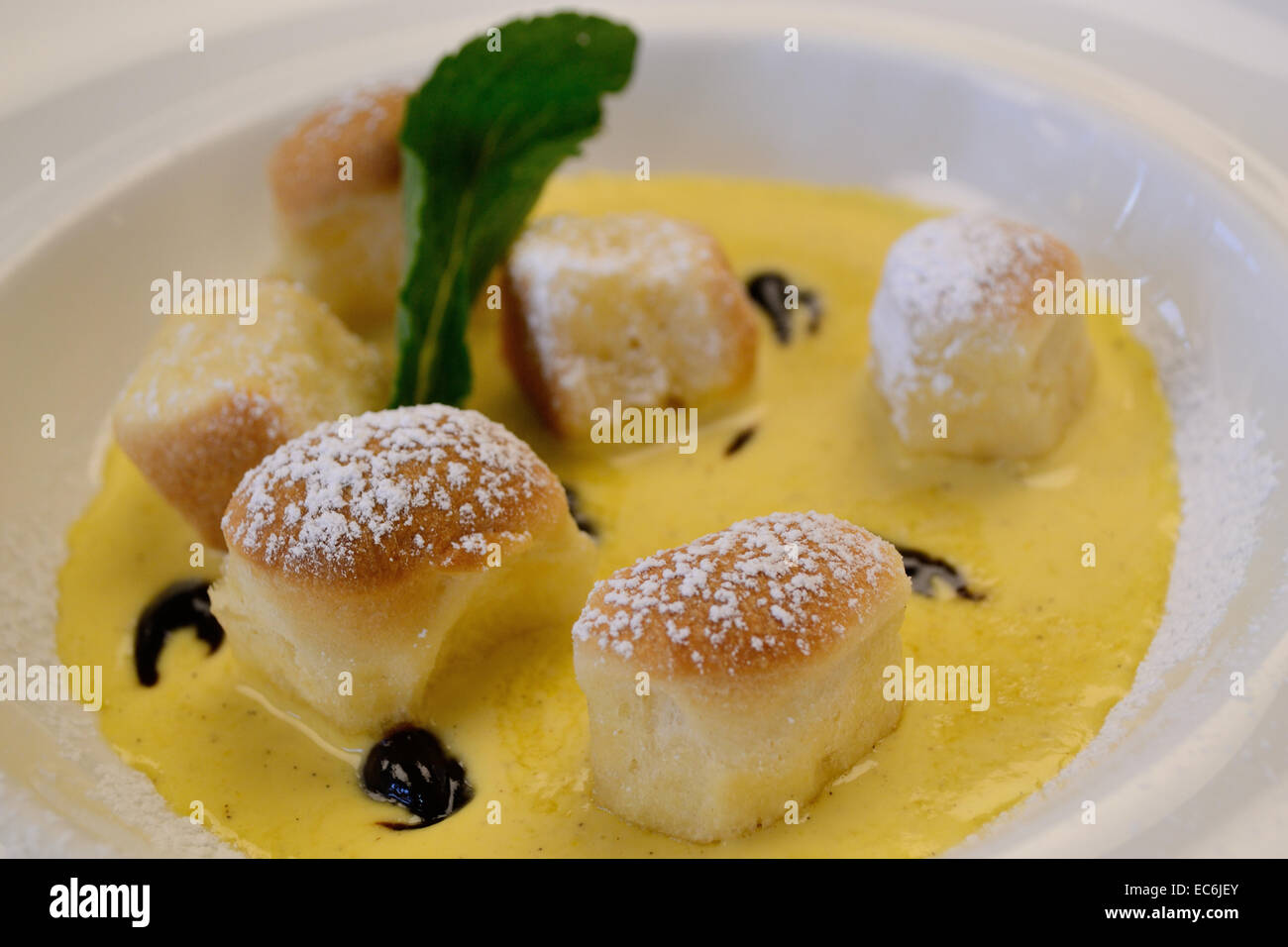 delicious dumplings on a plate garnished with vanilla sauce Stock Photo ...
