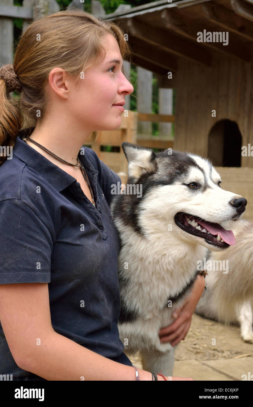 Teenager hugging Husky Stock Photo - Alamy