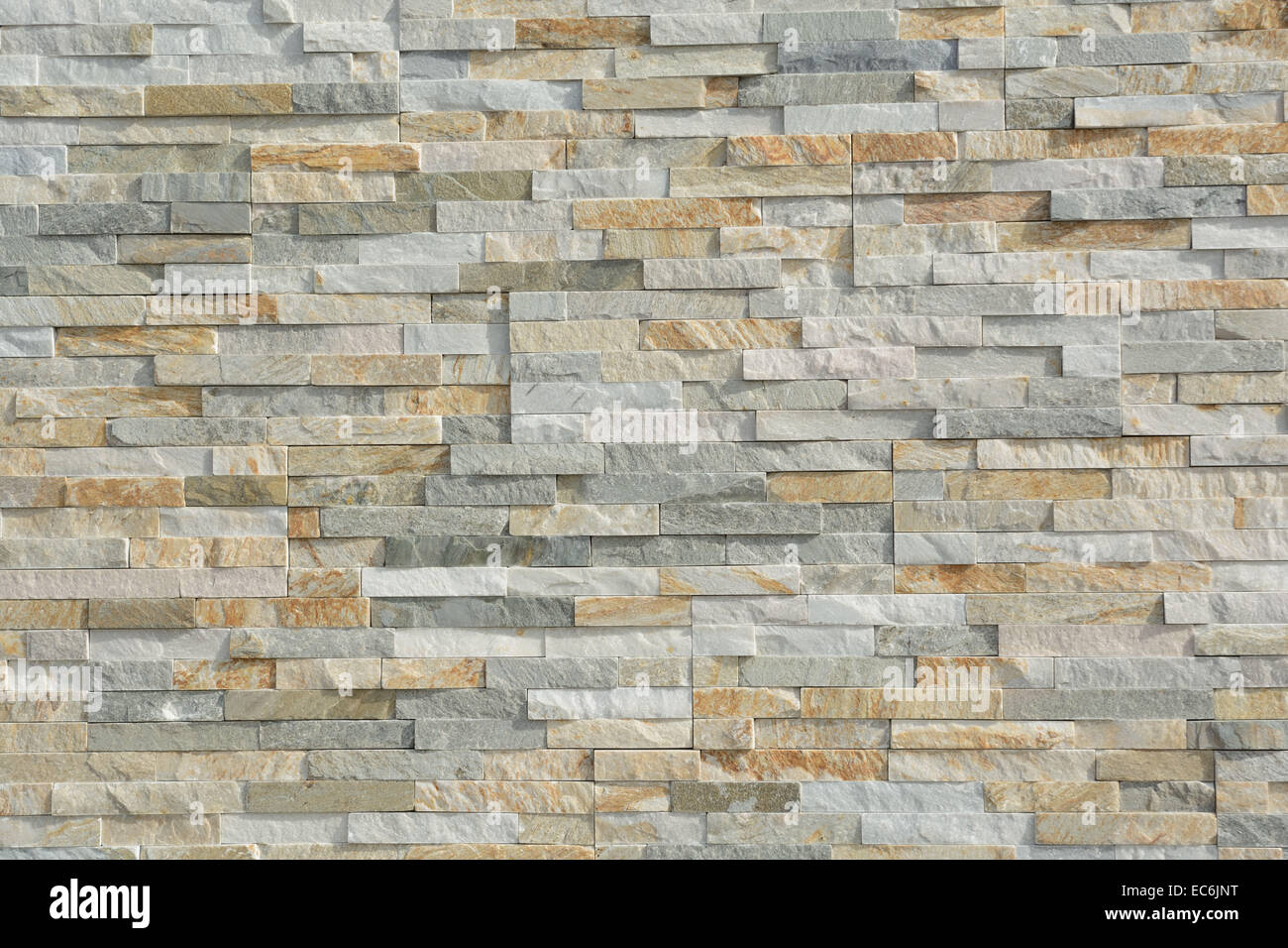 Natural stones form a pattern in a stone wall Stock Photo - Alamy