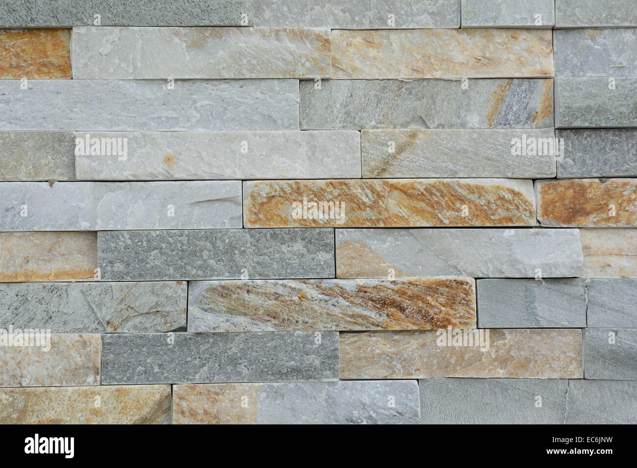 smooth natural stones form a stone wall Stock Photo - Alamy