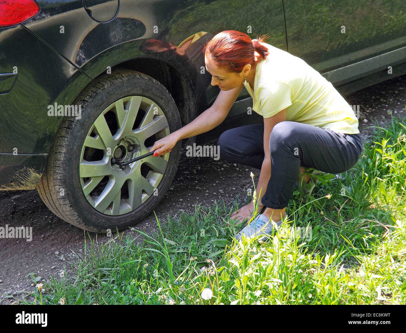 Person changing flat tire hi-res stock photography and images - Alamy