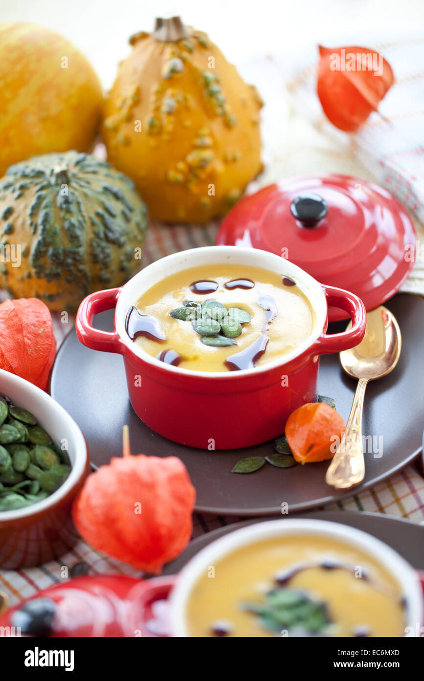 Pumpkin soup in little red pot Stock Photo - Alamy