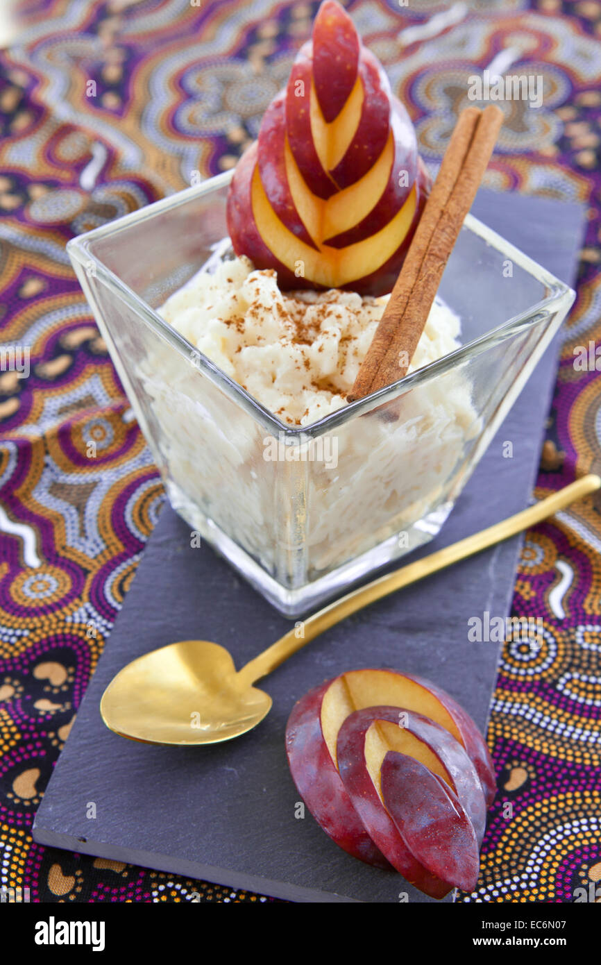 Rice pudding with plums and cinnamon Stock Photo - Alamy