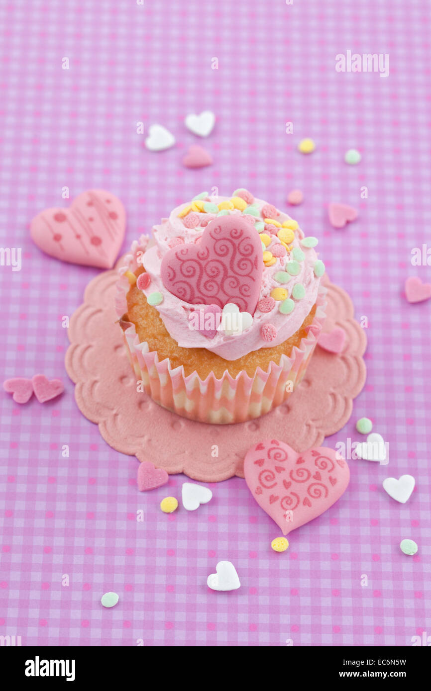 Little cupcake on purple Stock Photo - Alamy