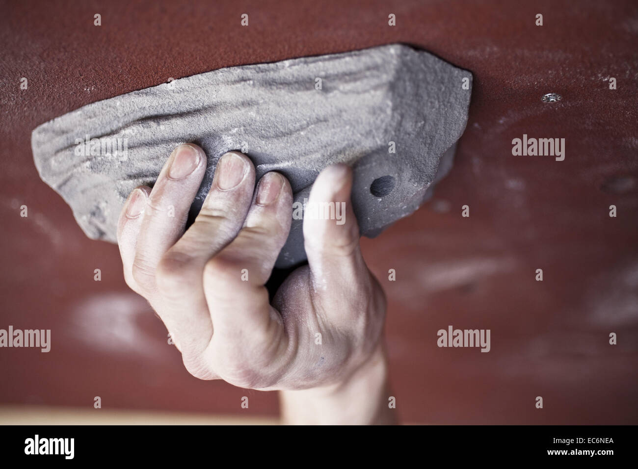 Climbers hand on a grip in an indoor climbing hall Stock Photo - Alamy