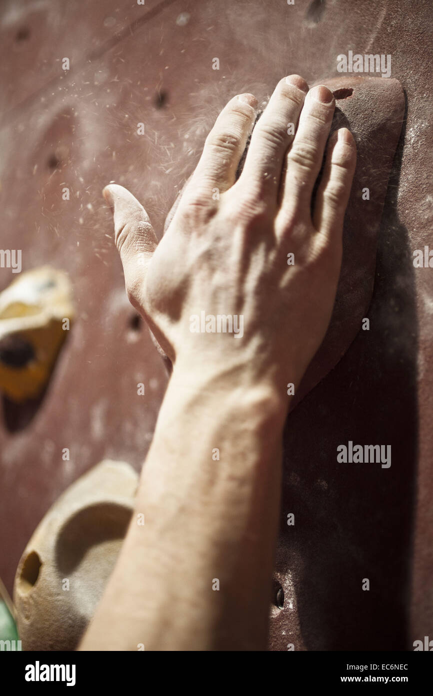 Climbers hand on a grip in an indoor climbing hall Stock Photo - Alamy