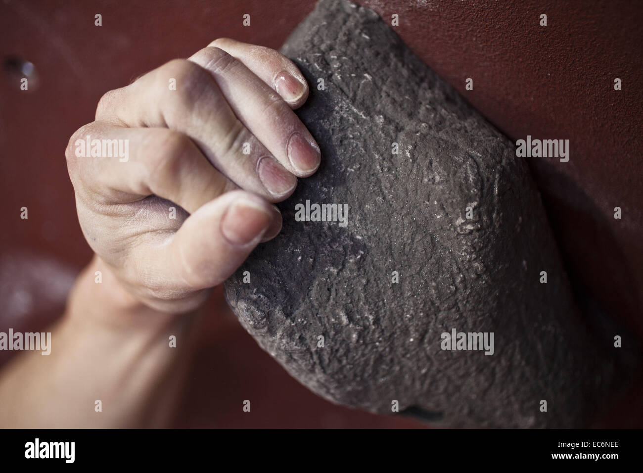 Climbers hand on a grip in an indoor climbing hall Stock Photo - Alamy
