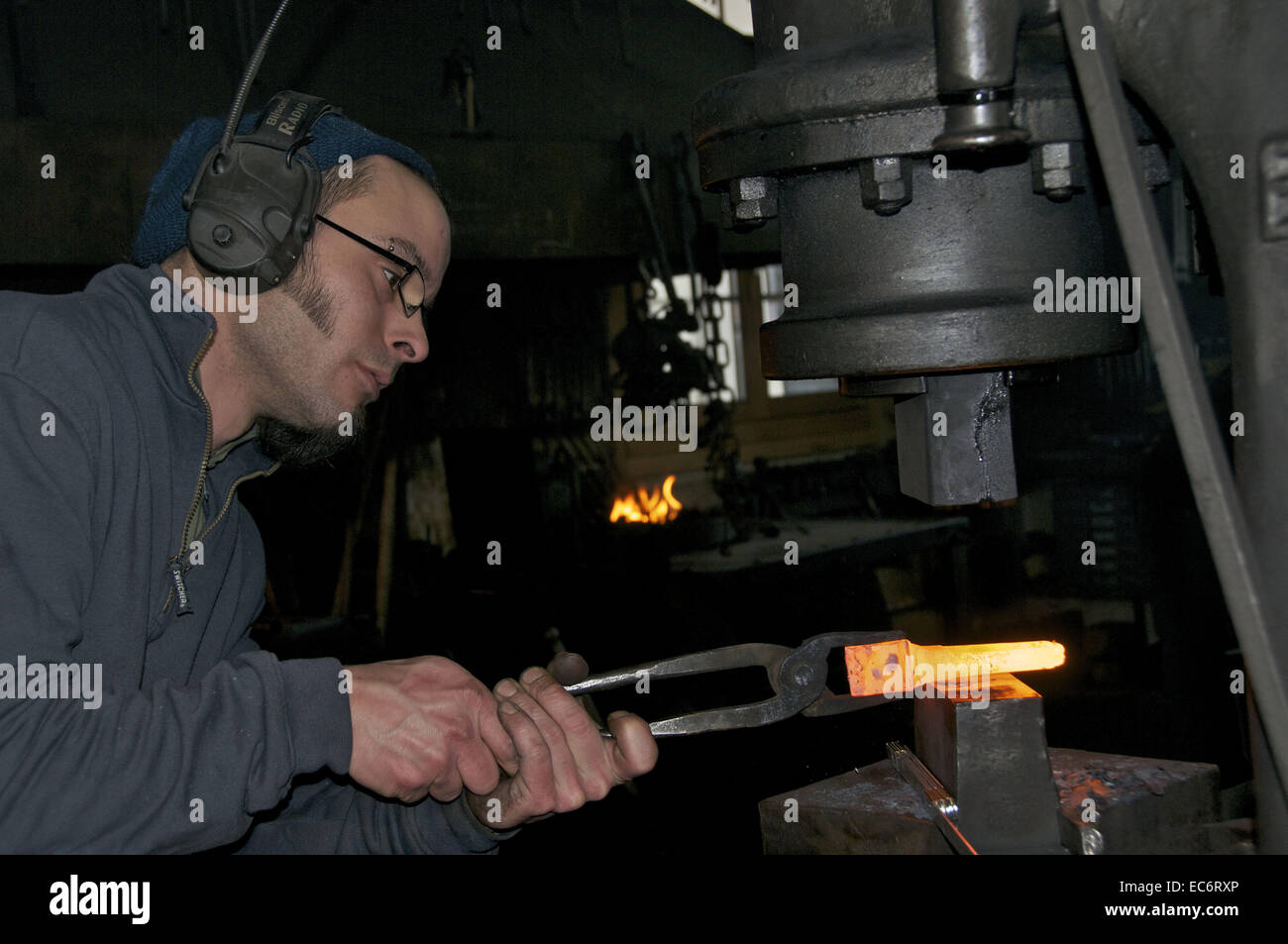 blacksmith working the steamhammer on redhot steel Stock Photo - Alamy