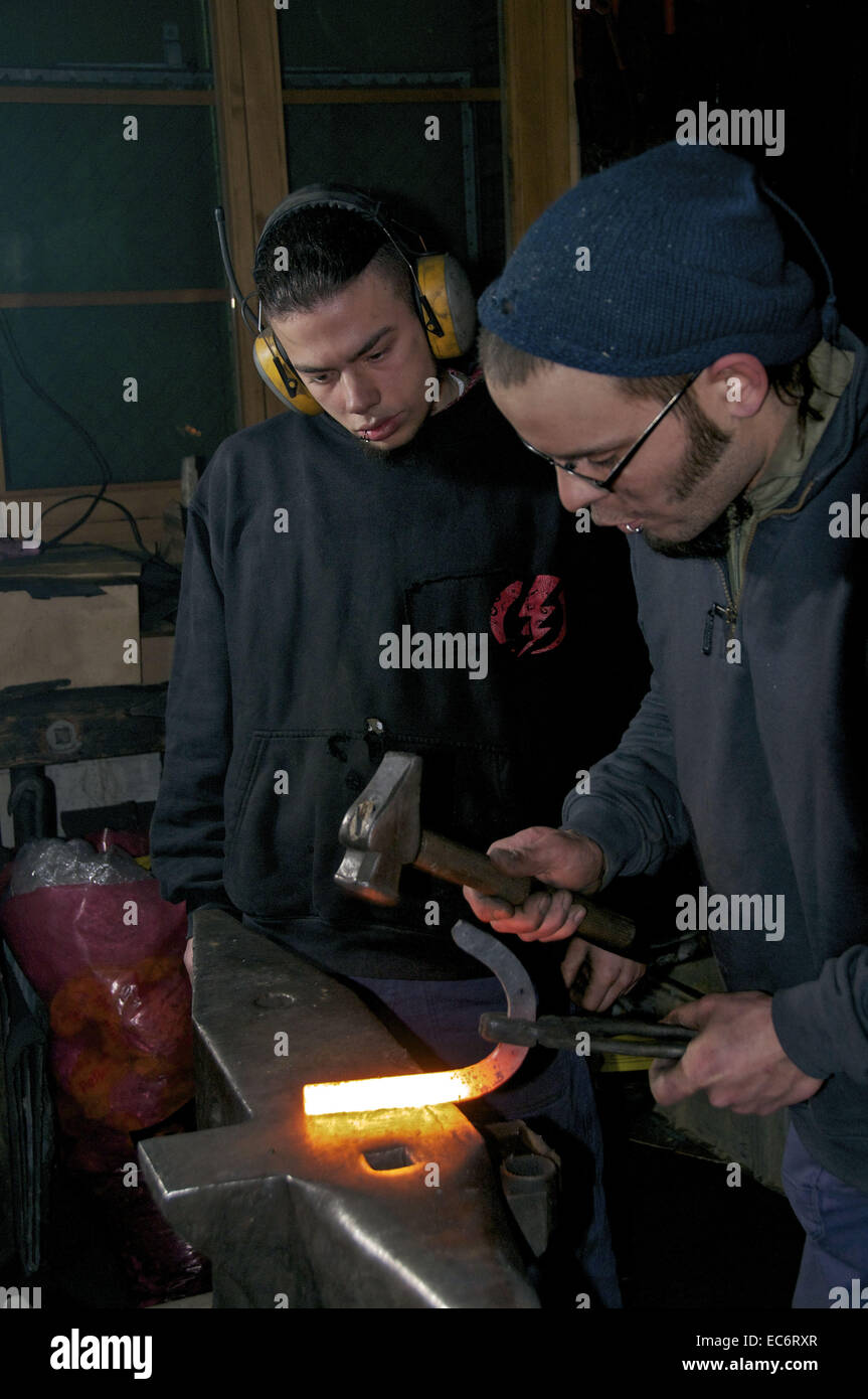 instruction of a blacksmith trainee Stock Photo - Alamy