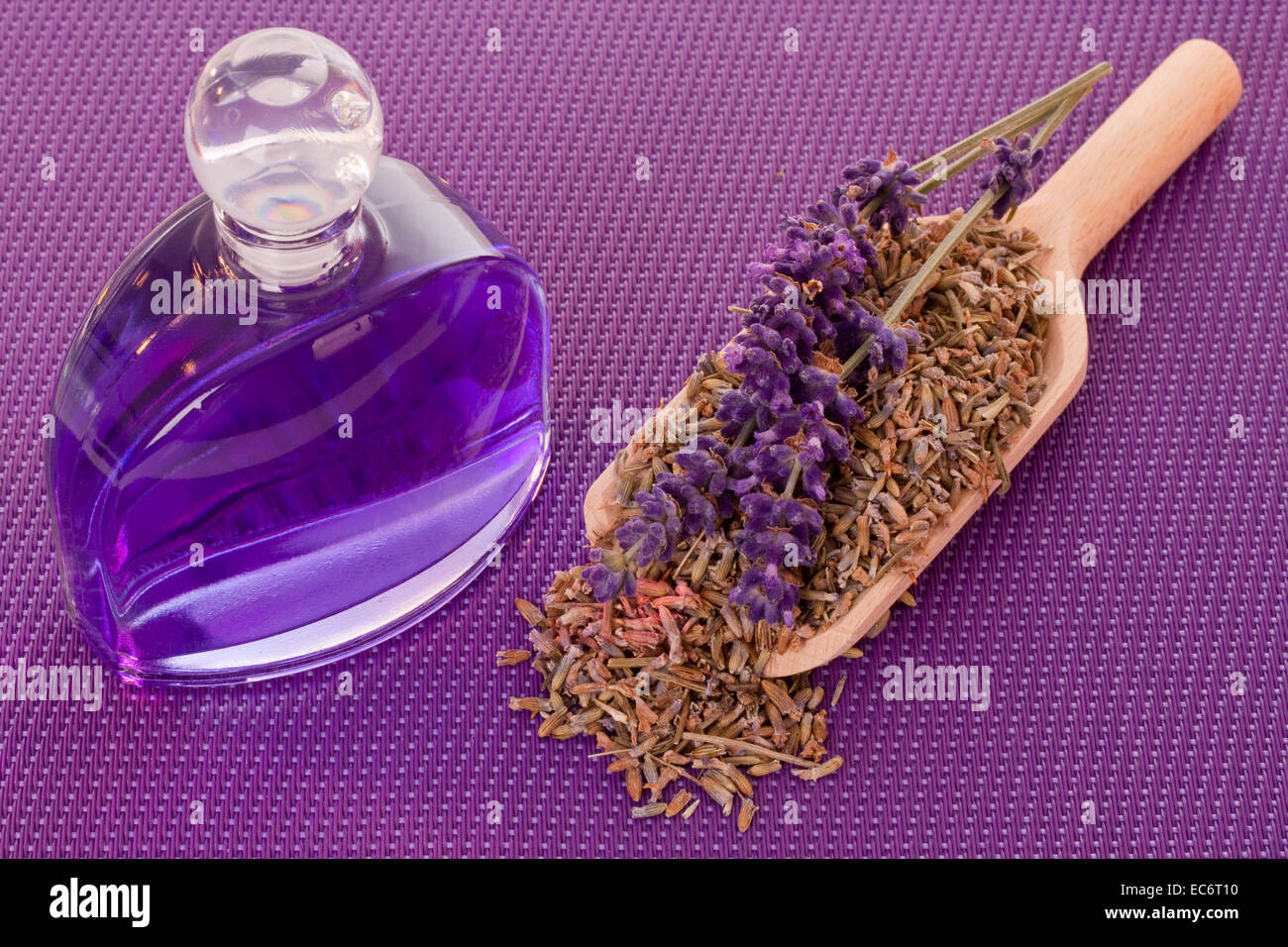 Bath essence with lavender over purple background Stock Photo - Alamy