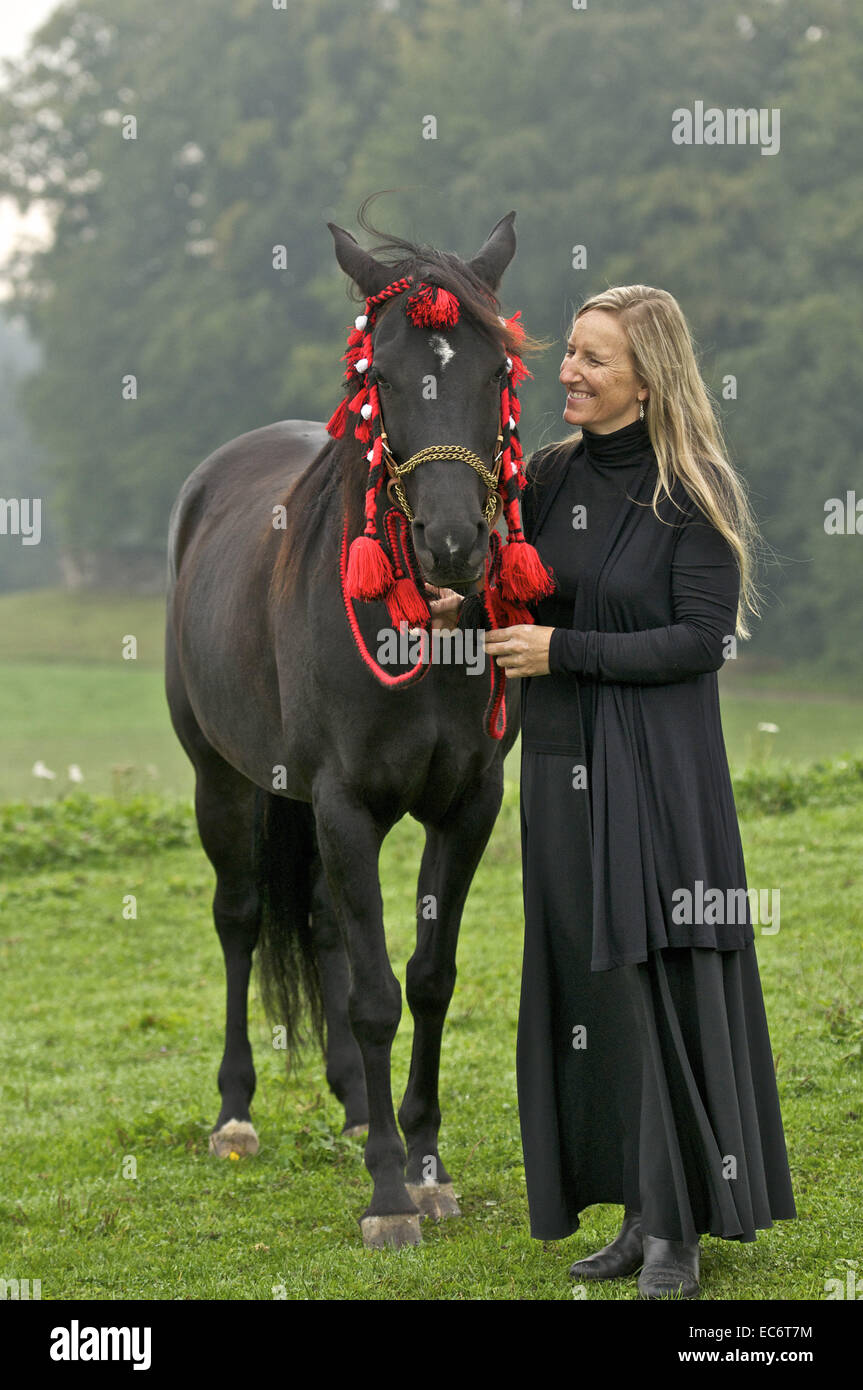blond woman with black arabian mare, red arabian stile bridle Stock ...