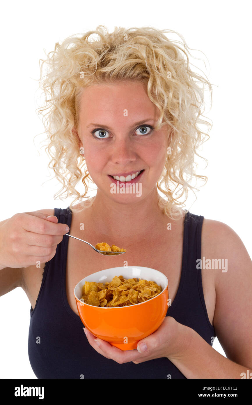 Young woman eating cornflakes Stock Photo - Alamy