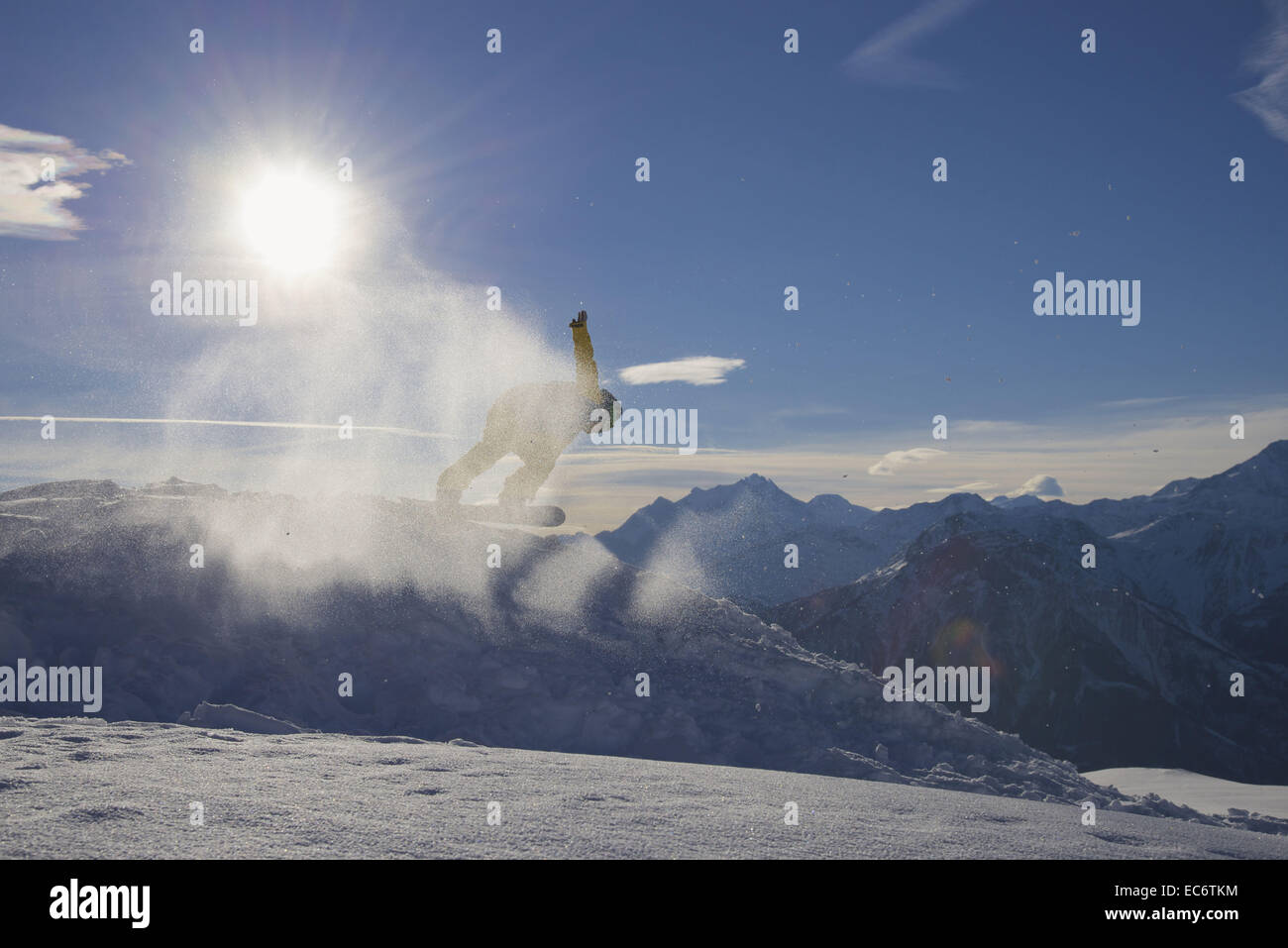 jumping snowboarder behind snowdust, silhouetted Stock Photo - Alamy