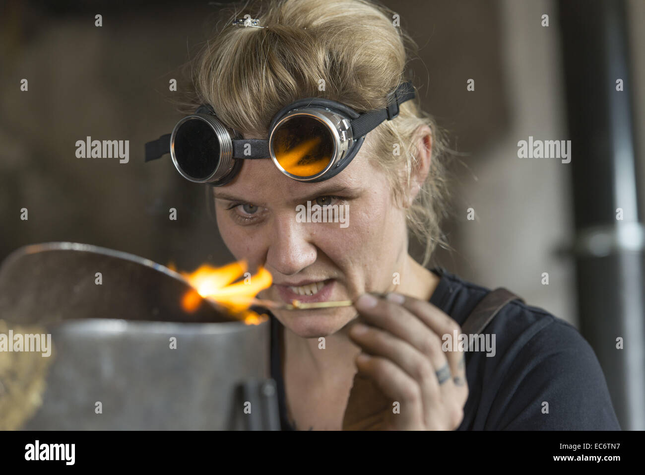young female blacksmith with goggles, soldering metal Stock Photo - Alamy