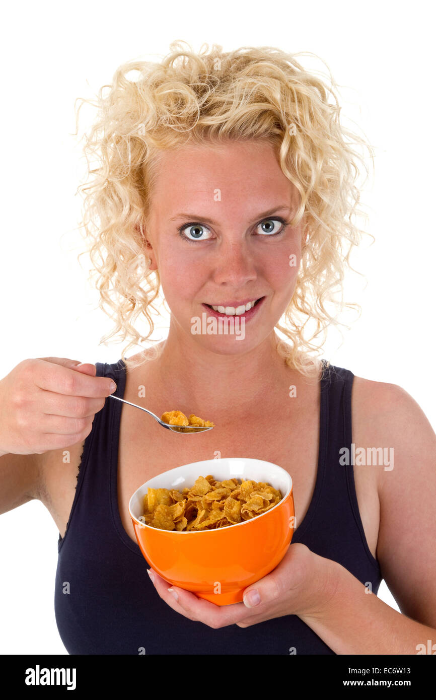 Young woman eating cornflakes from a bowl Stock Photo - Alamy