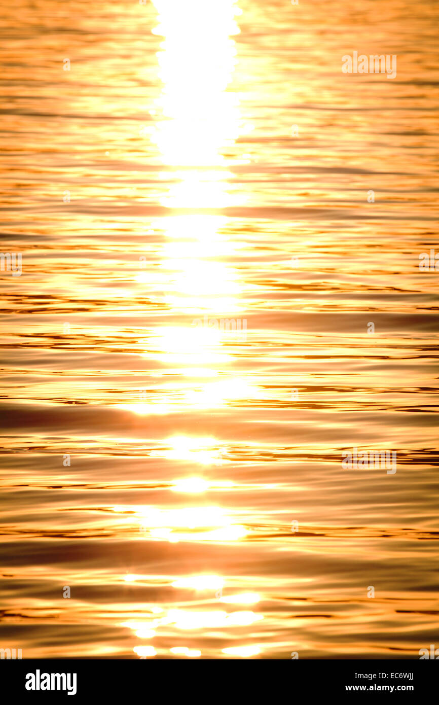 sunset reflected on the water surface of a lake Stock Photo - Alamy