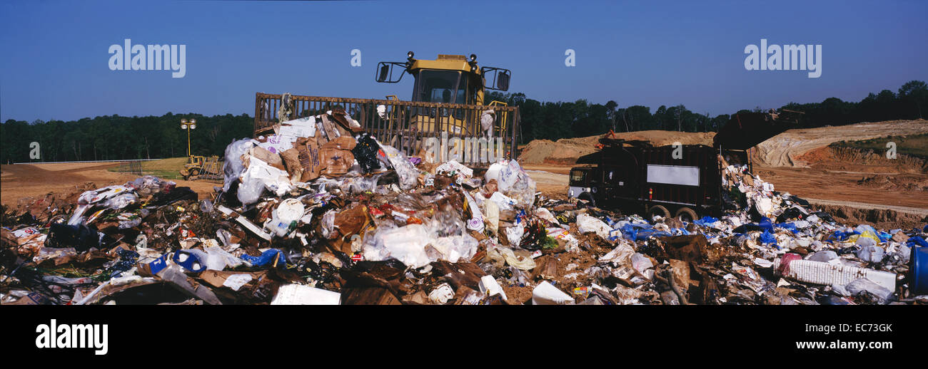 Heavy machinery moves refuse at sanitary landfill Stock Photo - Alamy