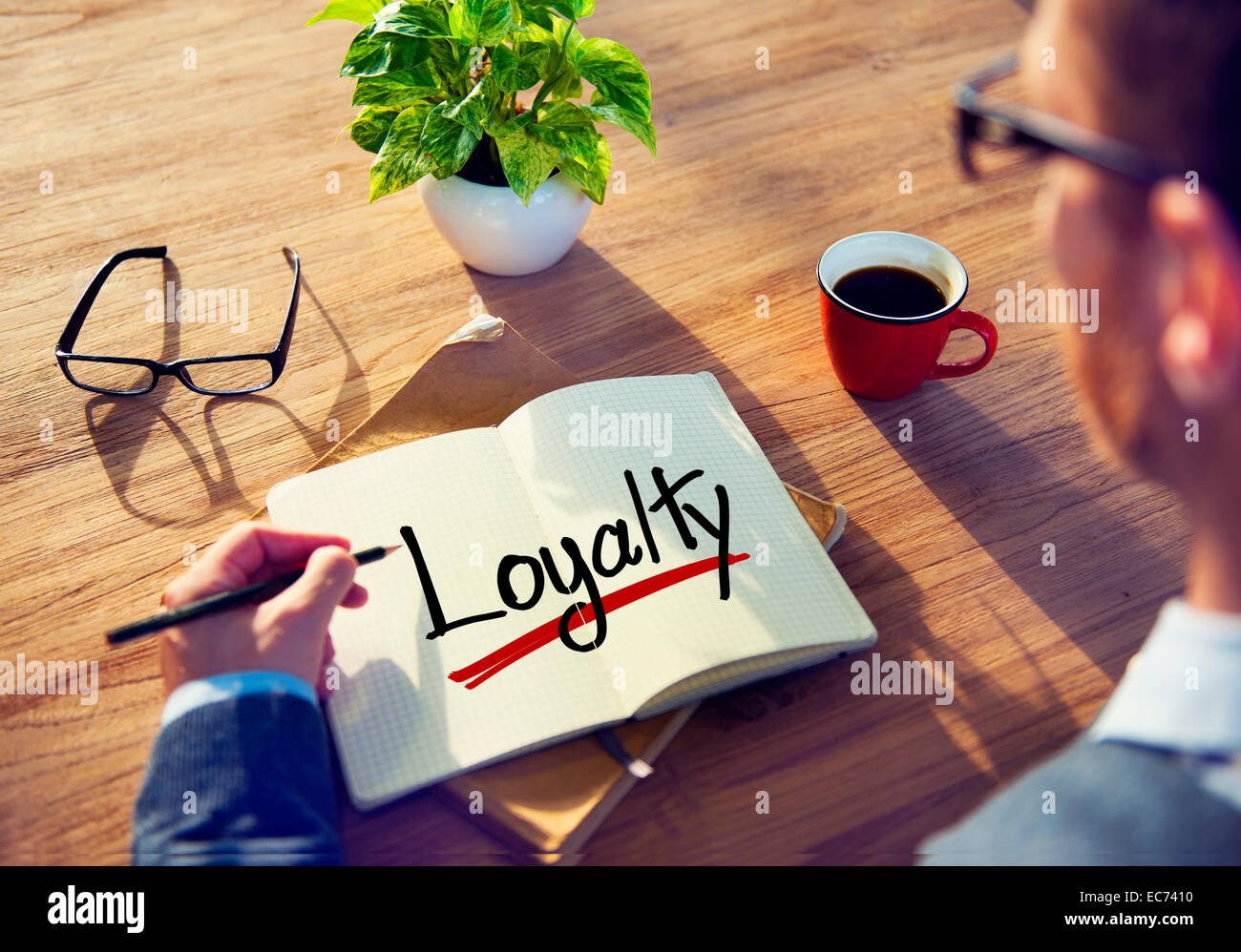 Man with a Note and a Single Word Loyalty Stock Photo - Alamy
