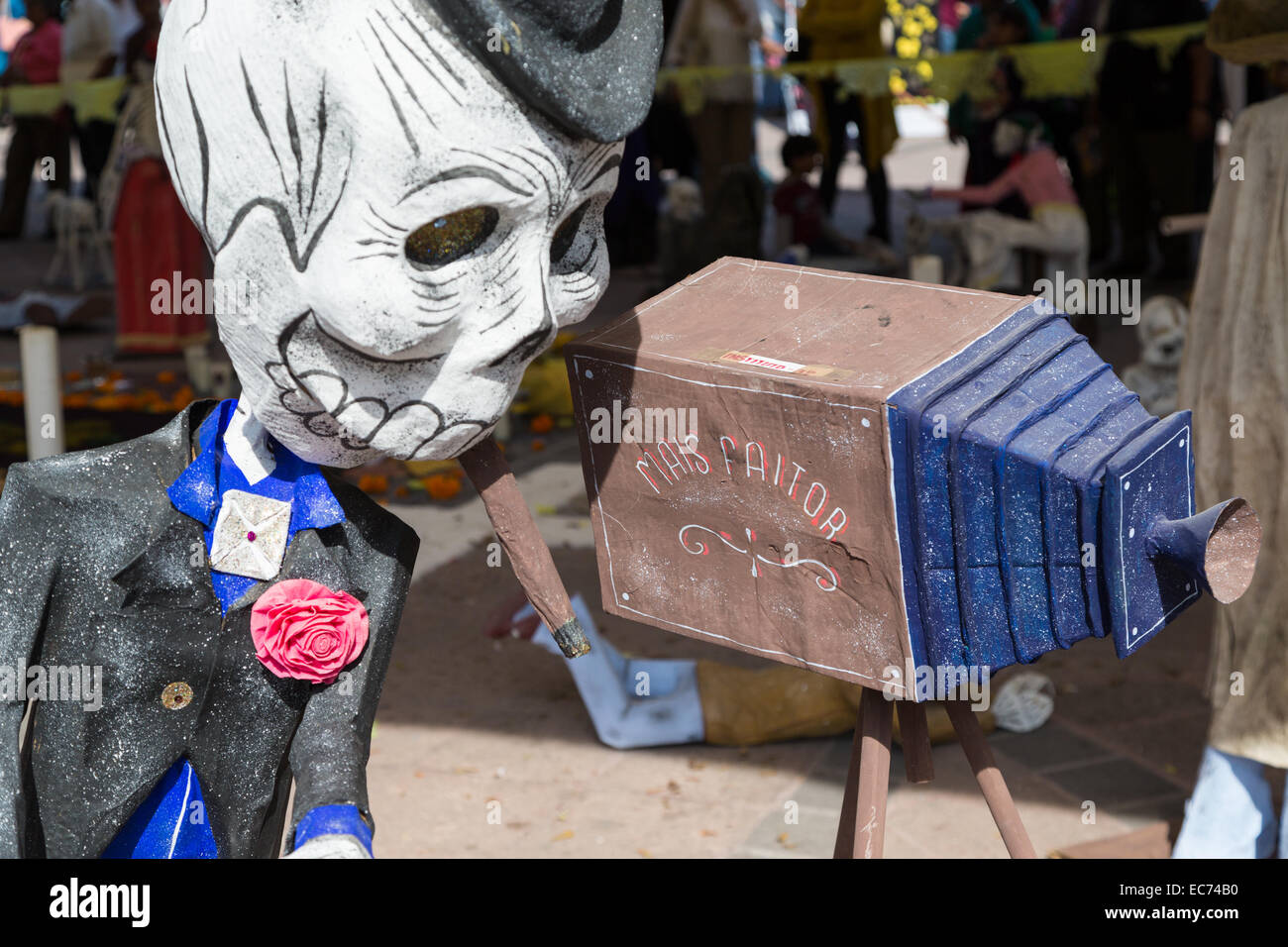 La Calaca with cigar posing as a photographer at dia de los muertos, a ...