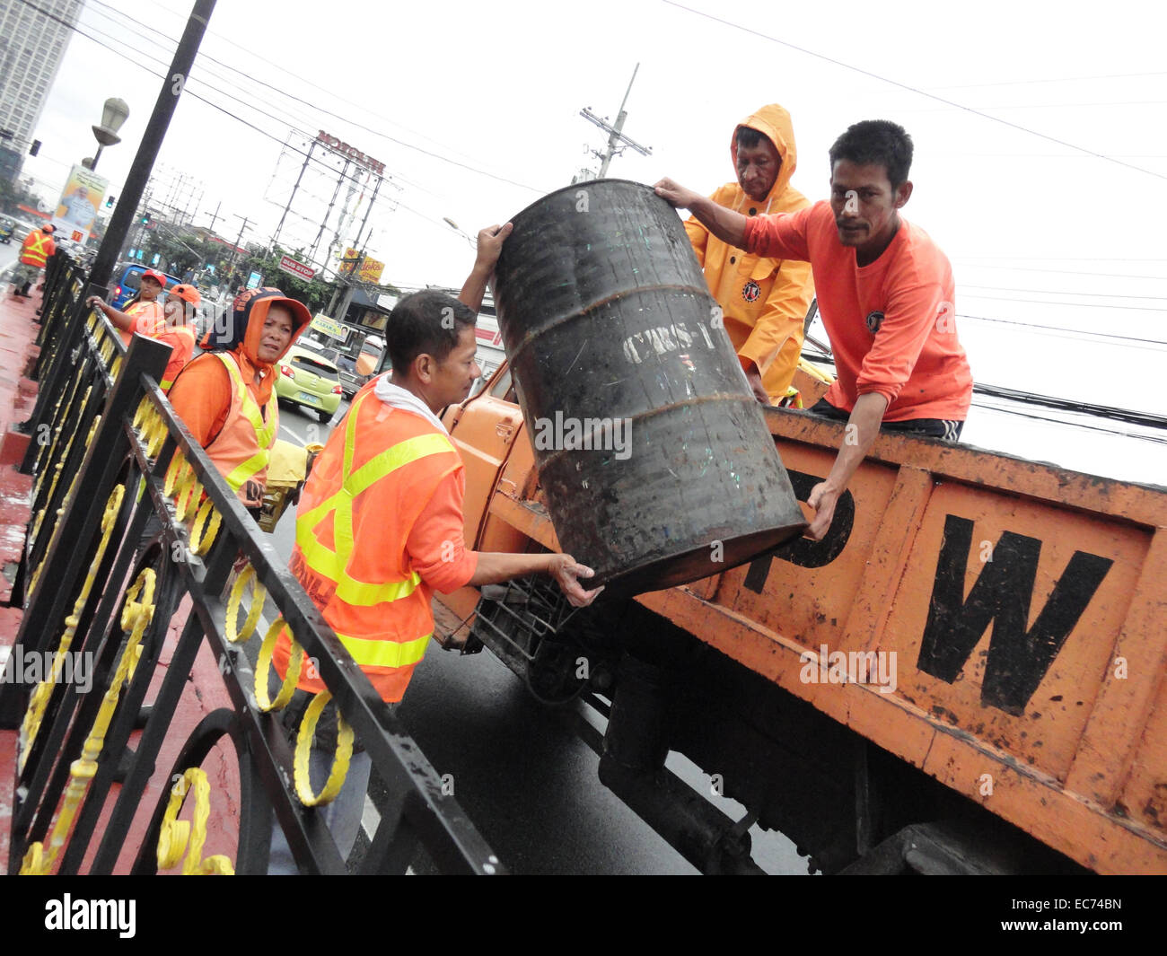 Workers from the Department of Public Works and Highways (DPWH) help ...