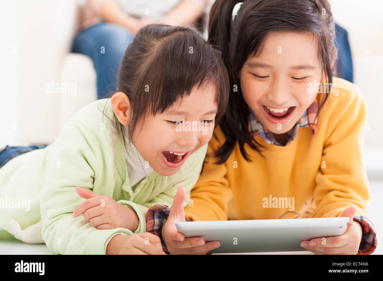 happy asian little girls using tablet computer Stock Photo - Alamy