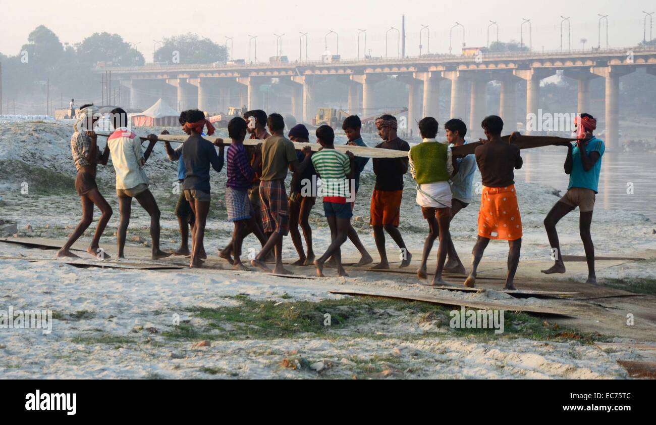 Worker carrying iron guarder to make a temoprary bridge on the river ...